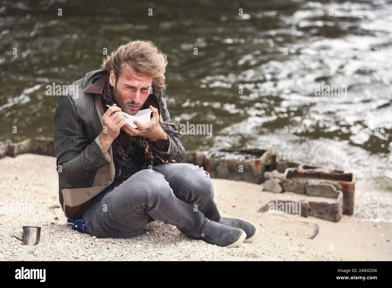 Portrait of poor homeless man eating food outdoors Stock Photo - Alamy