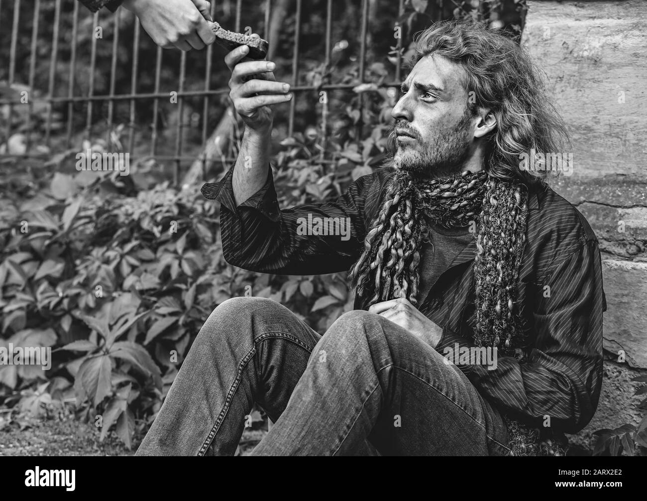 Woman giving bread to poor homeless man outdoors Stock Photo - Alamy