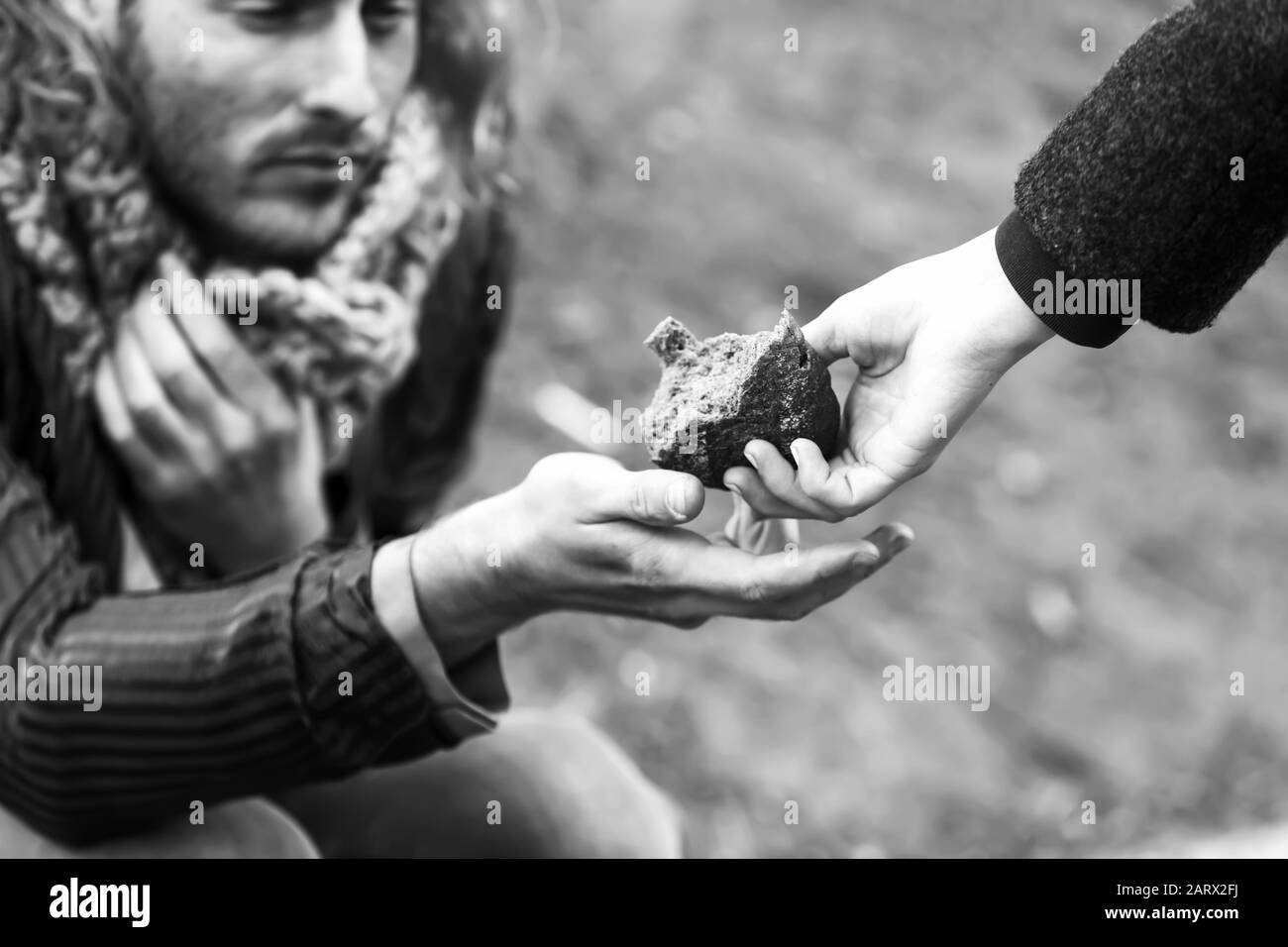 Woman giving bread to poor homeless man outdoors Stock Photo - Alamy