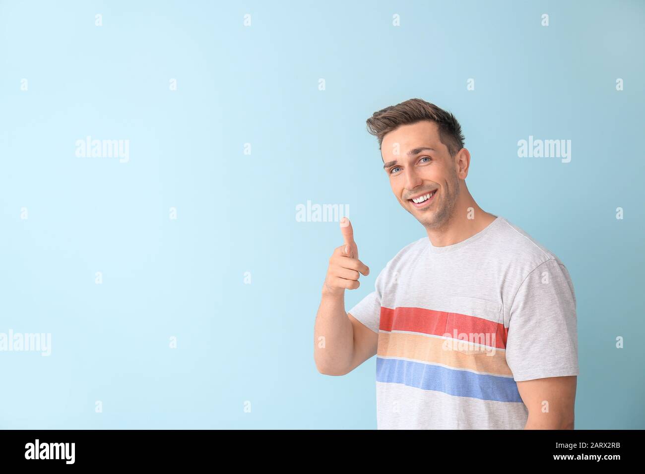 Positive young man pointing viewer hi-res stock photography and images ...