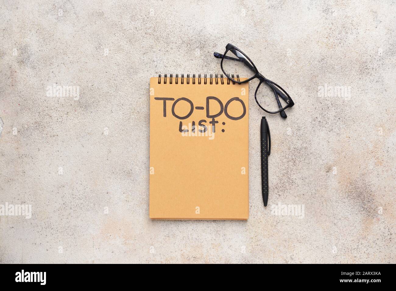 Empty to do list, glasses and pen on light background Stock Photo - Alamy