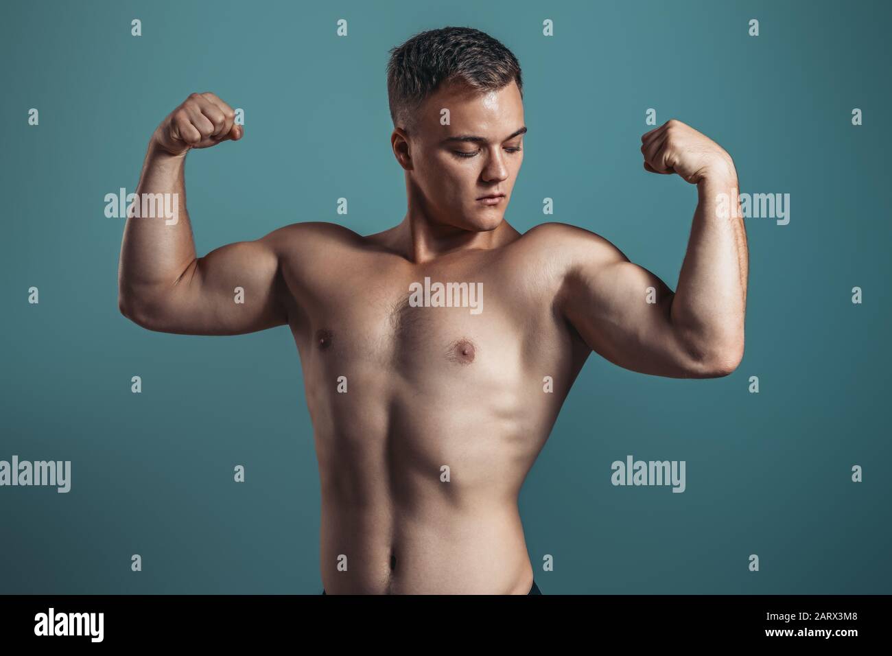 Handsome male bodybuilder on grey background Stock Photo - Alamy