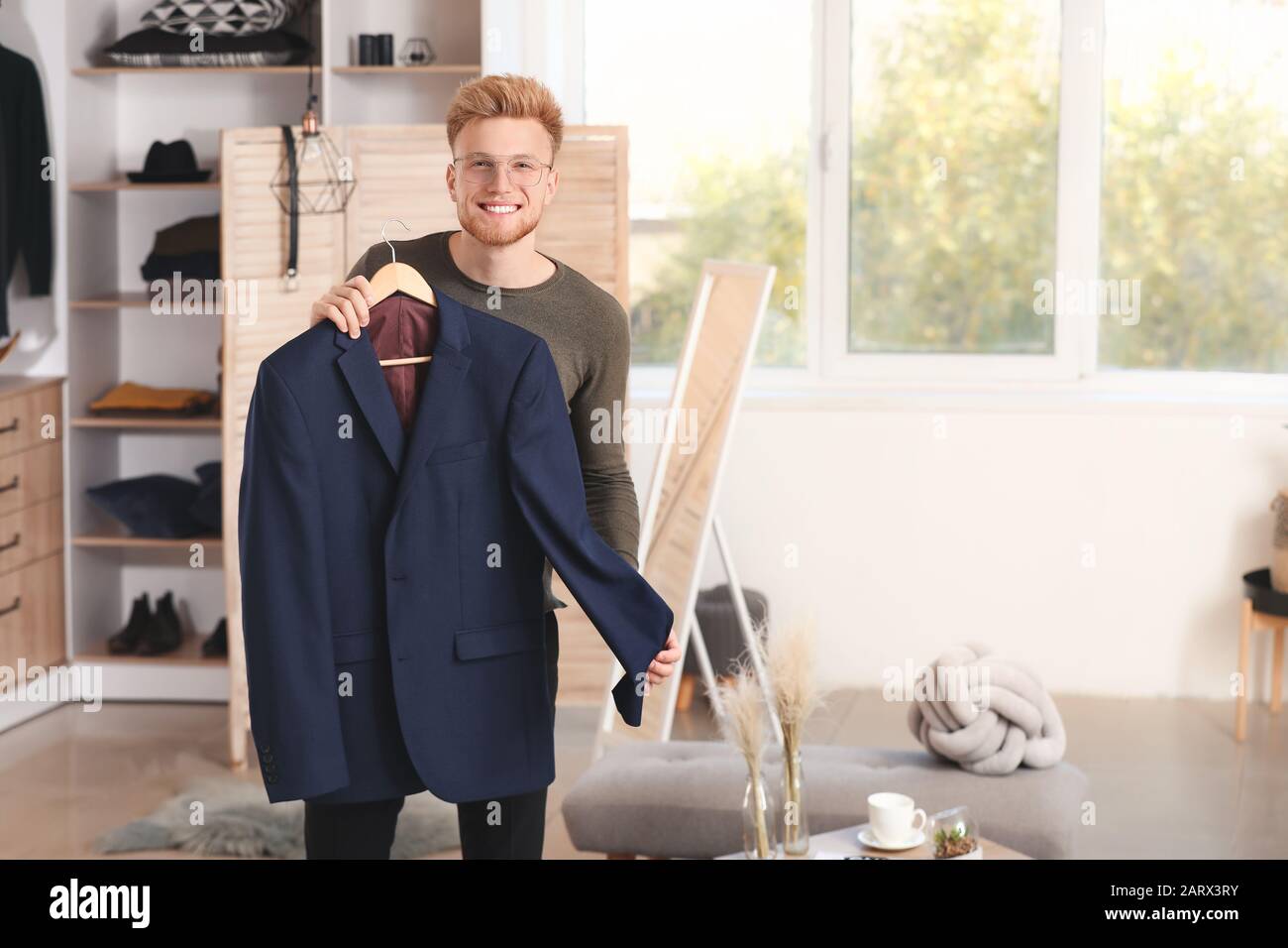 Handsome man with stylish clothes in dressing room Stock Photo - Alamy