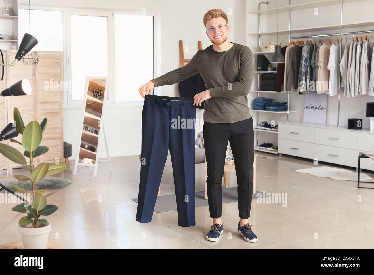 Handsome man with stylish clothes in dressing room Stock Photo - Alamy