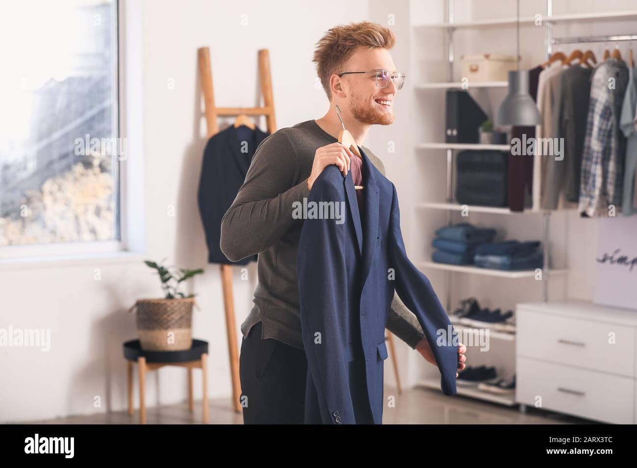 Handsome man with stylish clothes in dressing room Stock Photo - Alamy