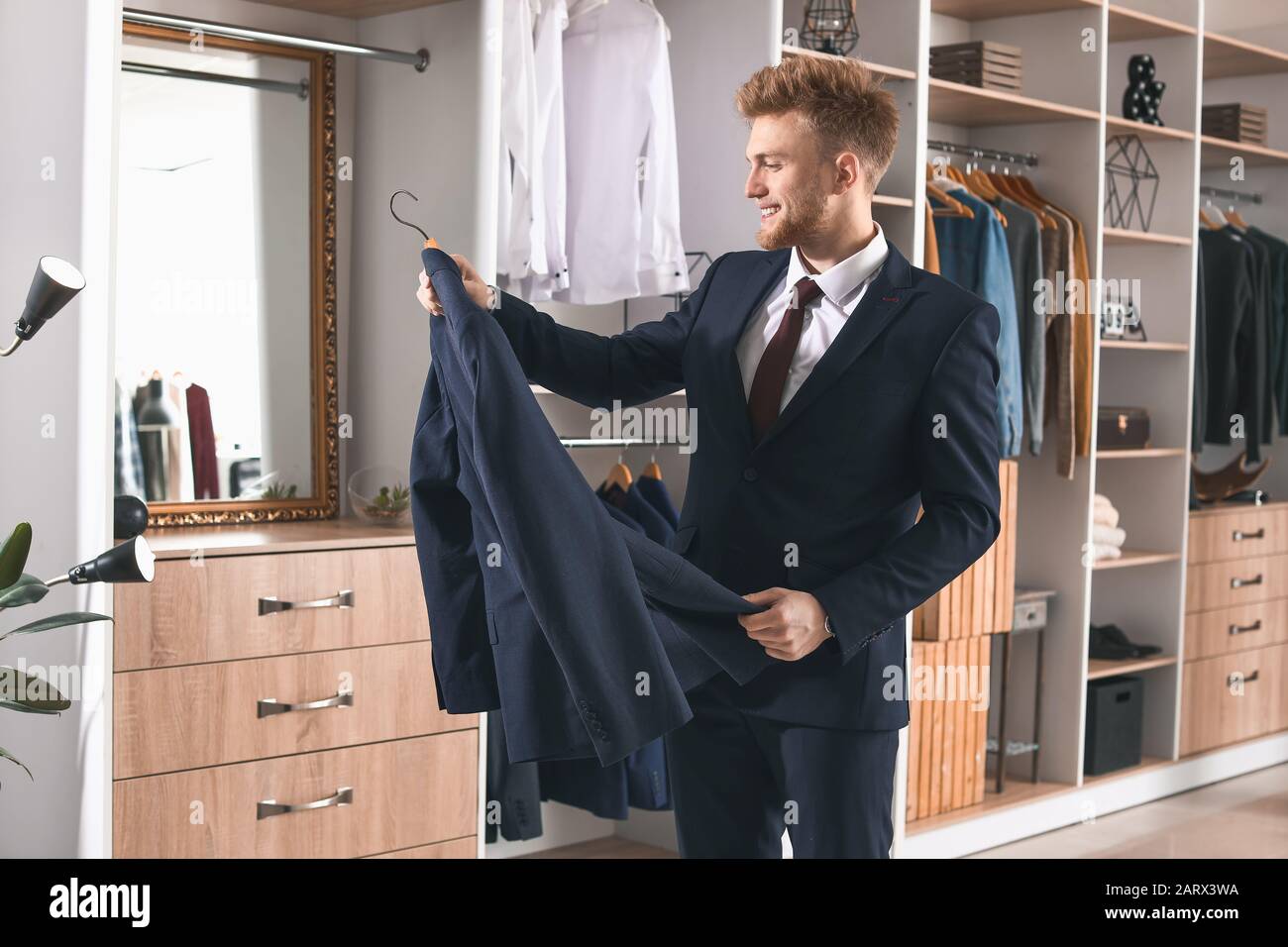Handsome man with stylish clothes in dressing room Stock Photo - Alamy