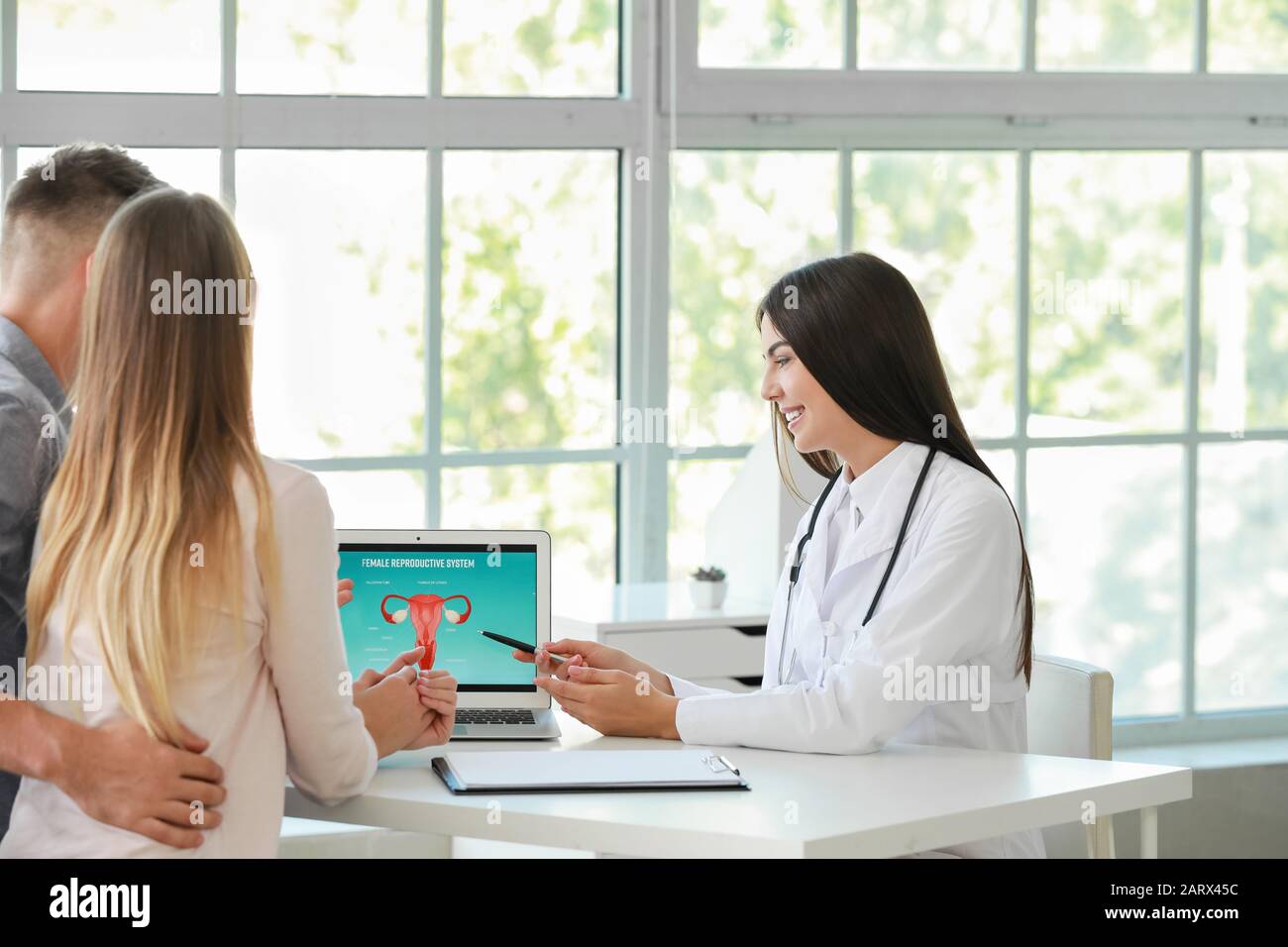 Couple visiting female gynecologist in clinic Stock Photo - Alamy