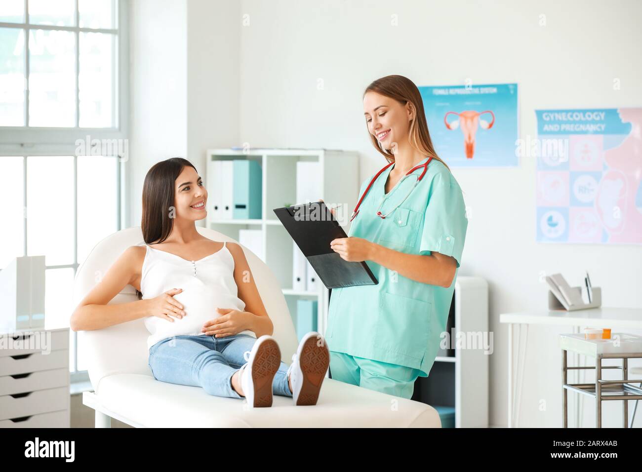 Female gynecologist working with pregnant woman in clinic Stock Photo ...