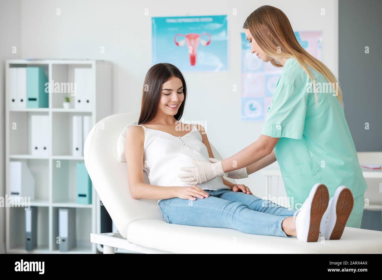 Female gynecologist working with pregnant woman in clinic Stock Photo ...