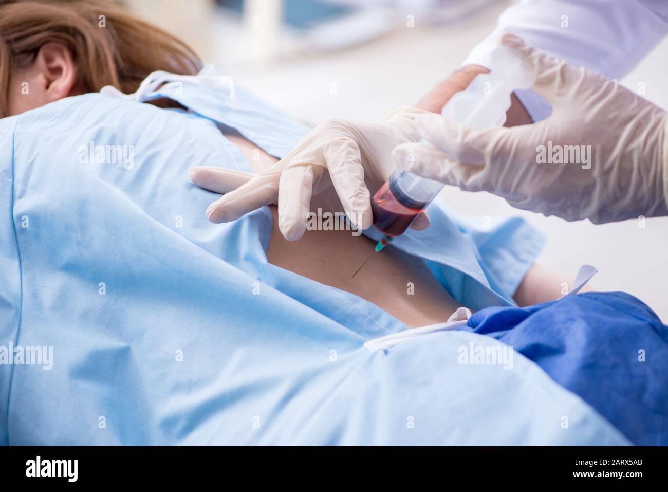 The female patient getting an injection in the clinic Stock Photo - Alamy