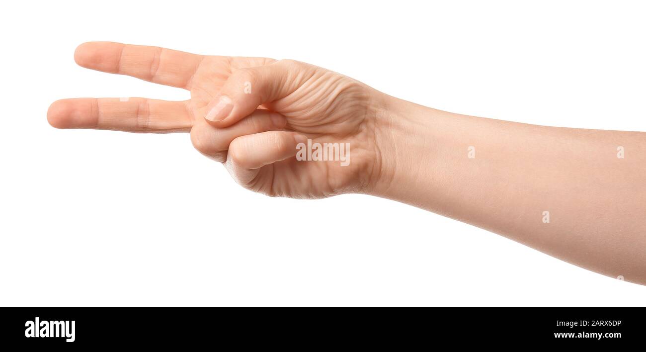 Hand of woman showing victory gesture on white background Stock Photo ...