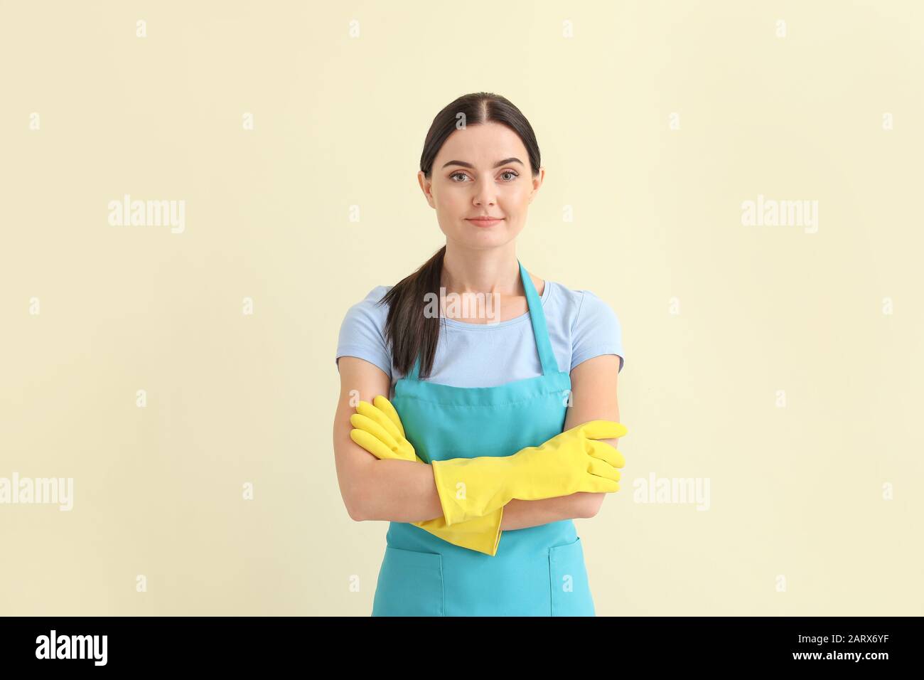Female janitor on light background Stock Photo - Alamy