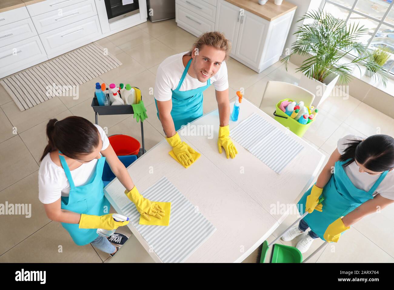 Team of janitors cleaning kitchen Stock Photo - Alamy
