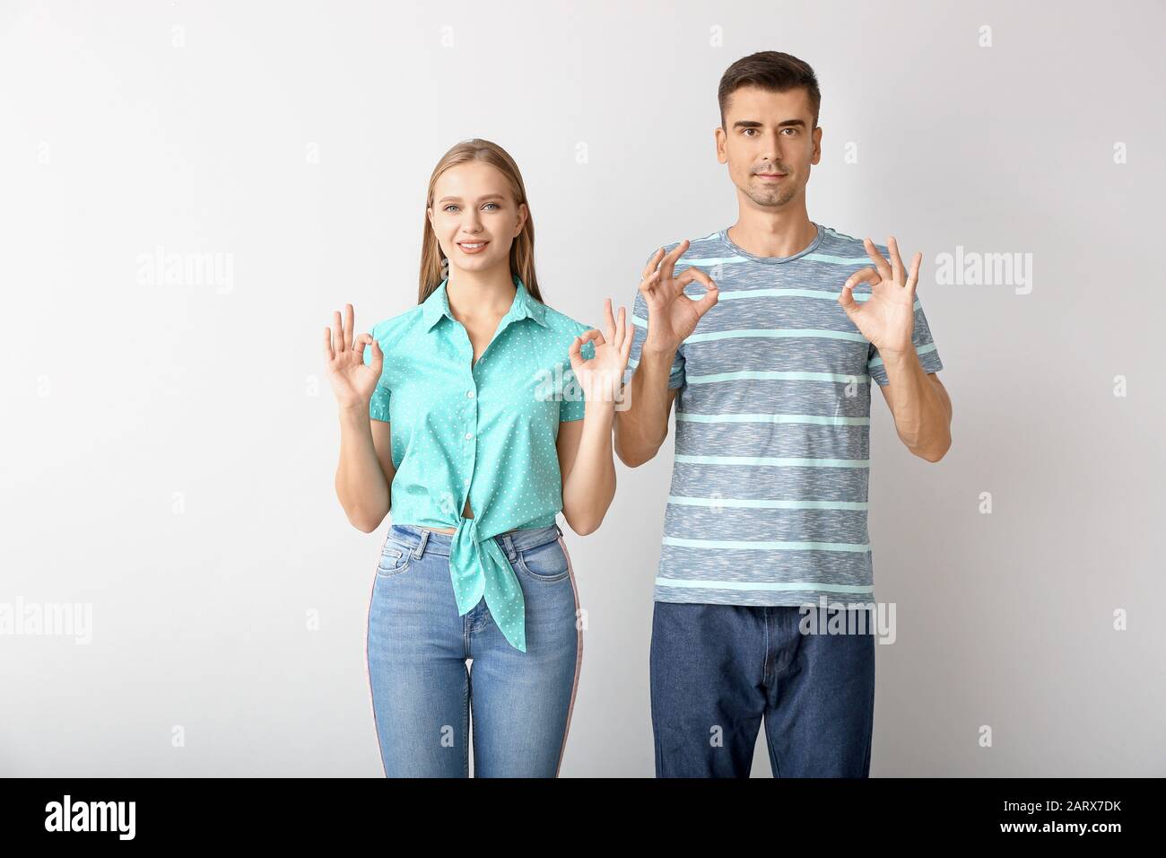 Young deaf mute couple using sign language on white background Stock ...