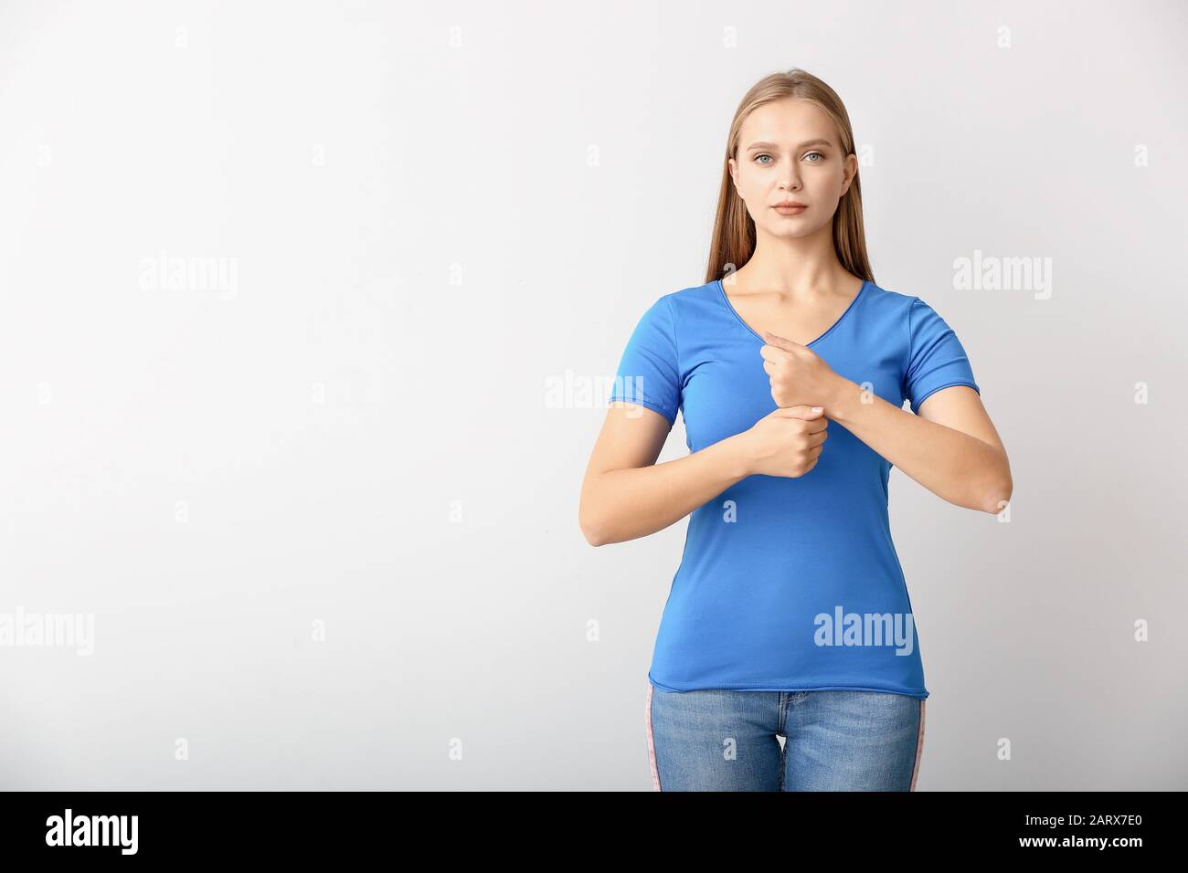Young deaf mute woman using sign language on white background Stock ...