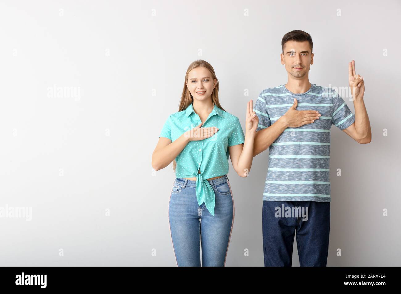 Young deaf mute couple using sign language on white background Stock ...