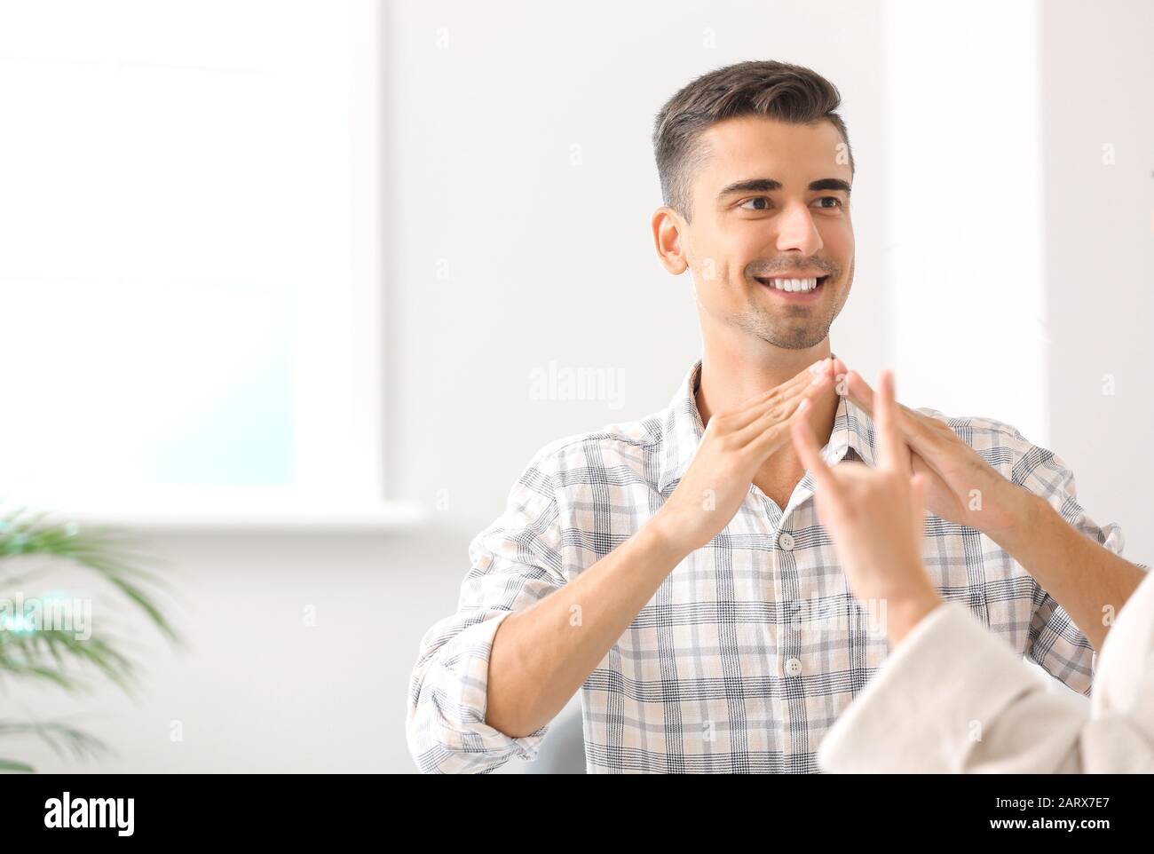 Young deaf mute couple using sign language at home Stock Photo - Alamy