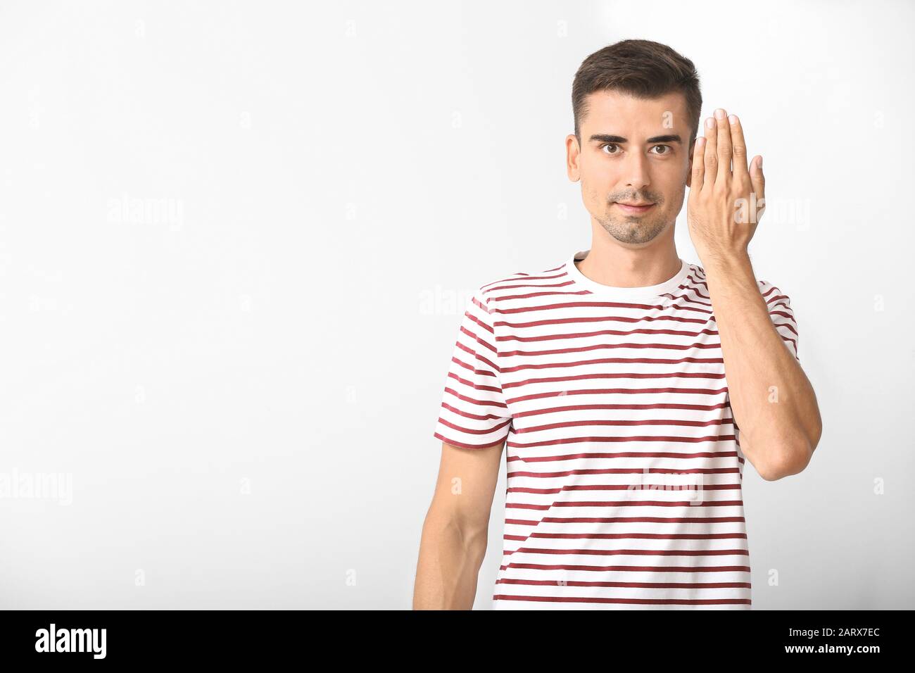Young deaf mute man using sign language on white background Stock Photo ...