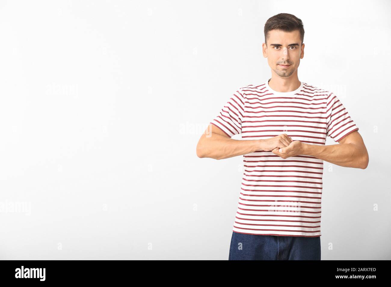 Young deaf mute man using sign language on white background Stock Photo ...