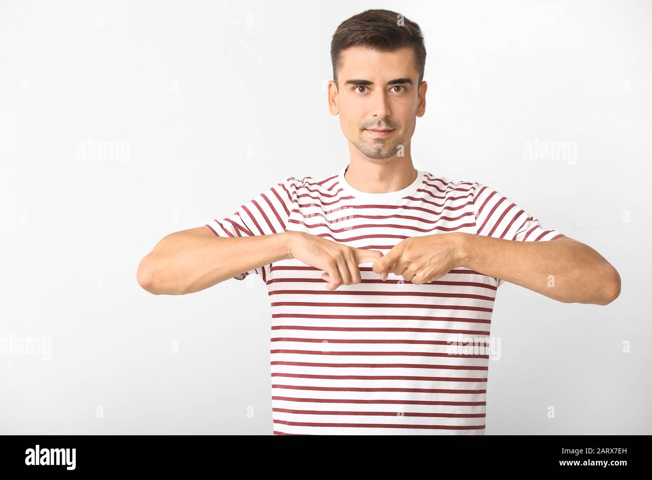 Young deaf mute man using sign language on white background Stock Photo ...
