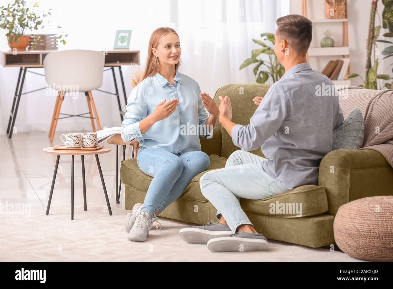 Young deaf mute couple using sign language at home Stock Photo - Alamy