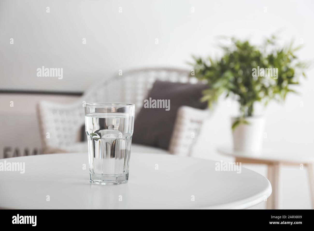 Glass of fresh water on table in room Stock Photo - Alamy