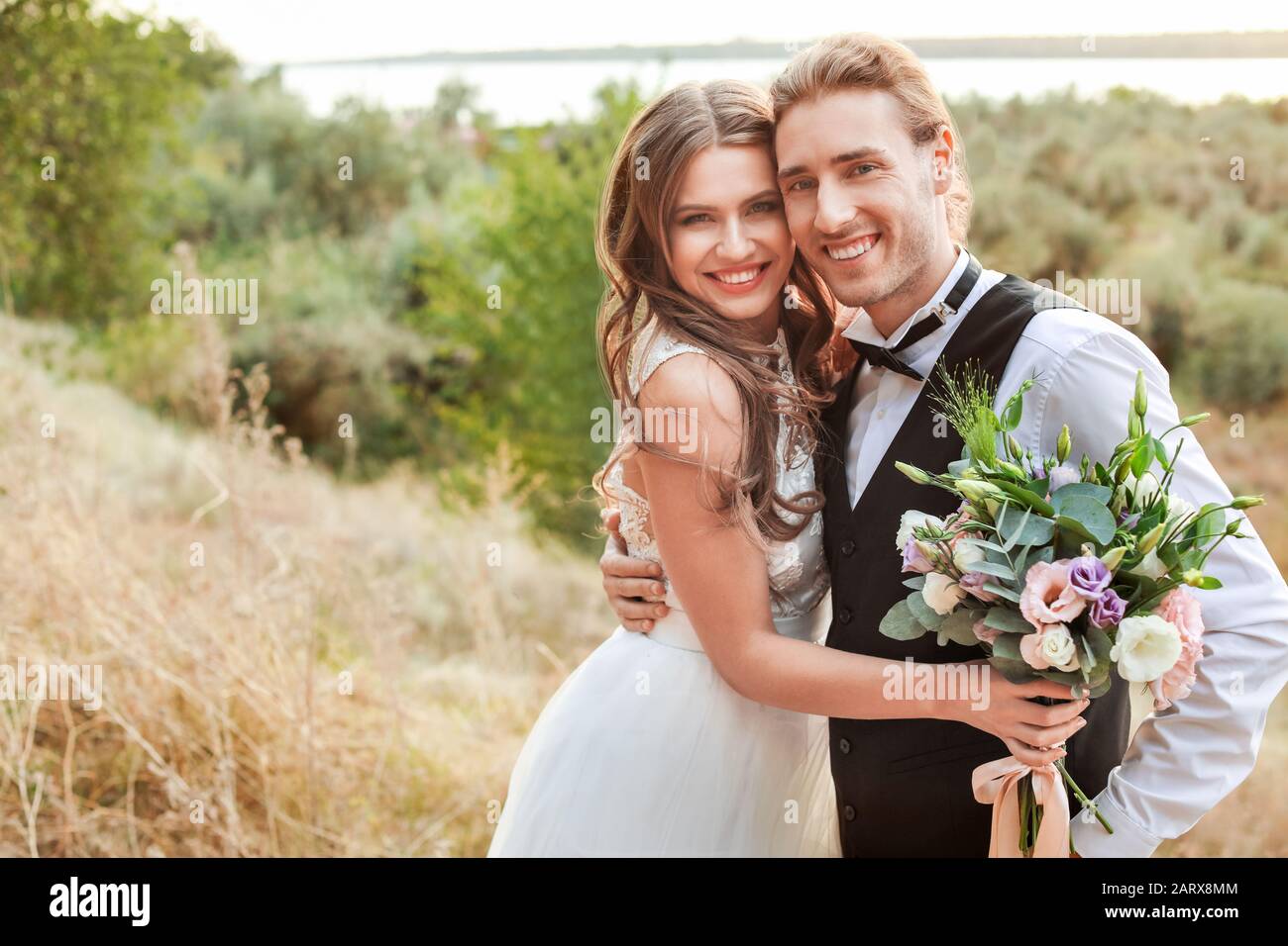 Happy couple celebrating their wedding outdoors Stock Photo - Alamy