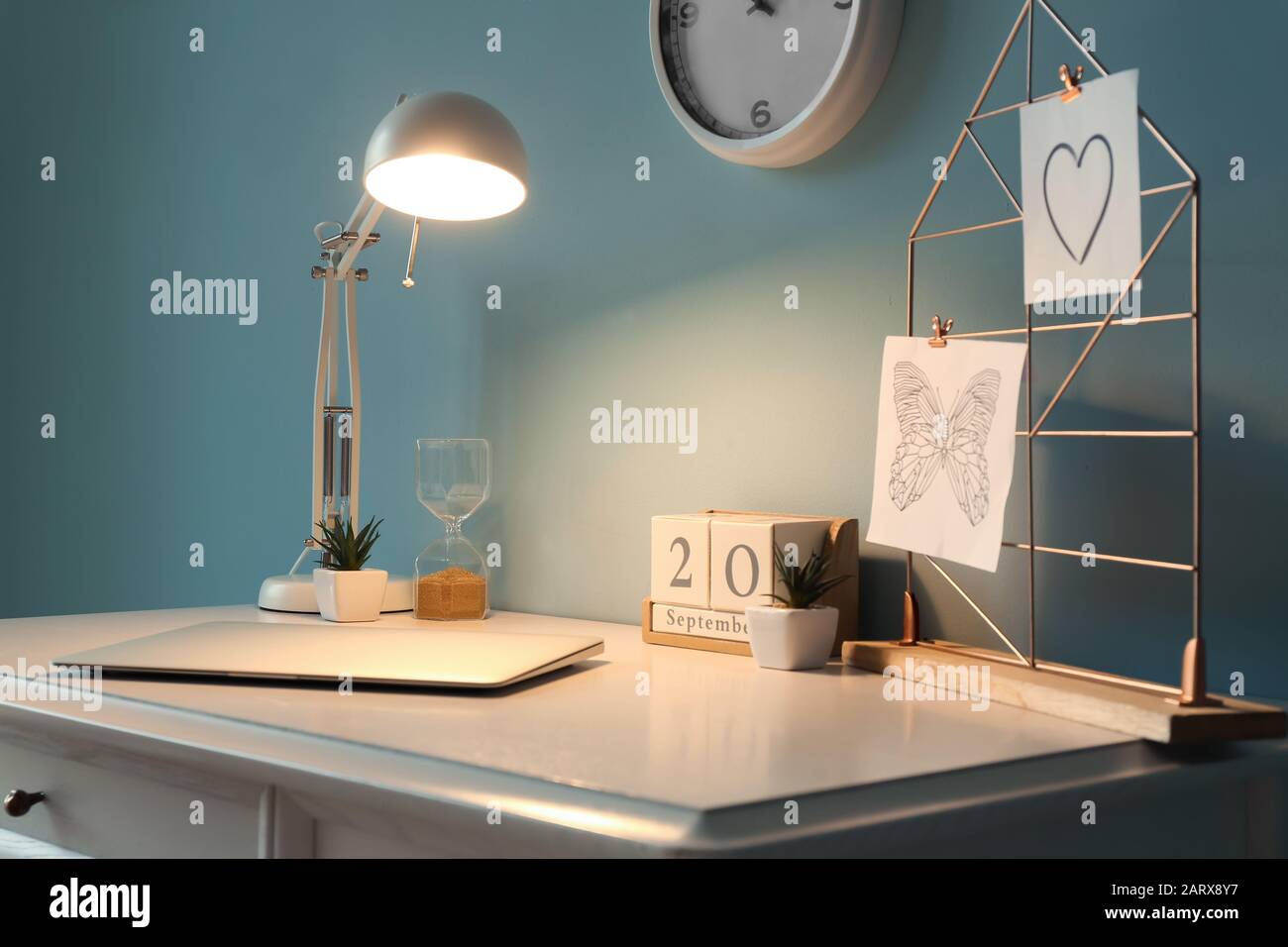 Modern stylish workplace with glowing lamp Stock Photo - Alamy