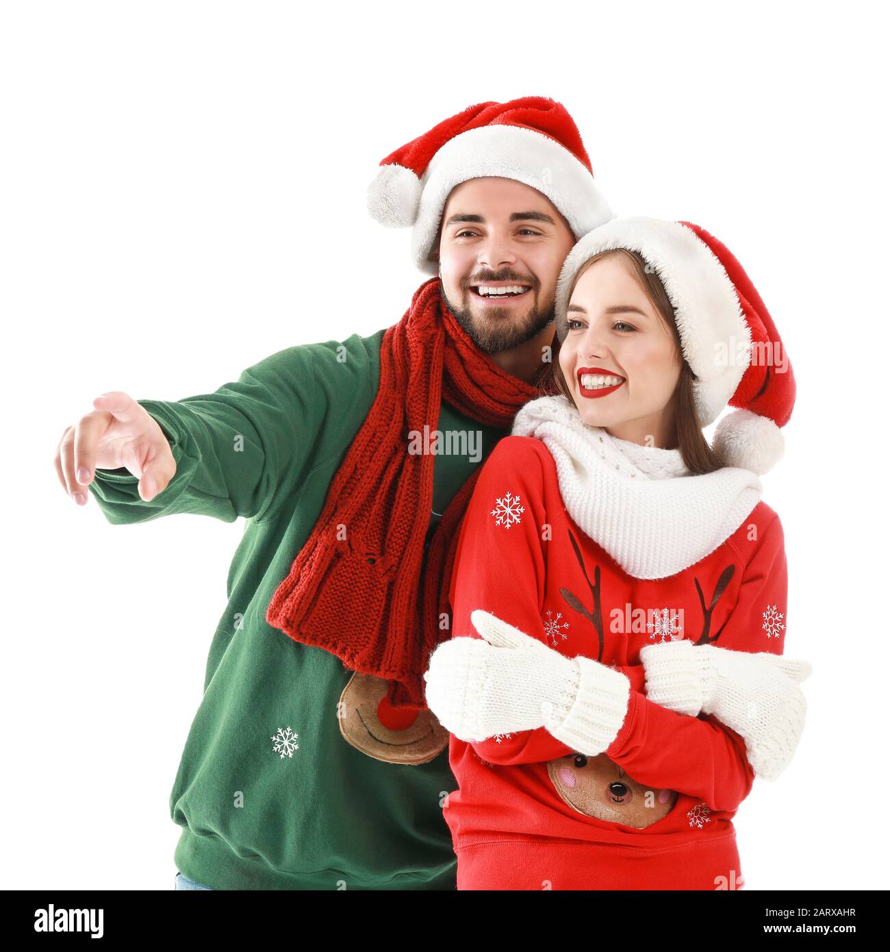 Happy young couple in Christmas clothes on white background Stock Photo ...