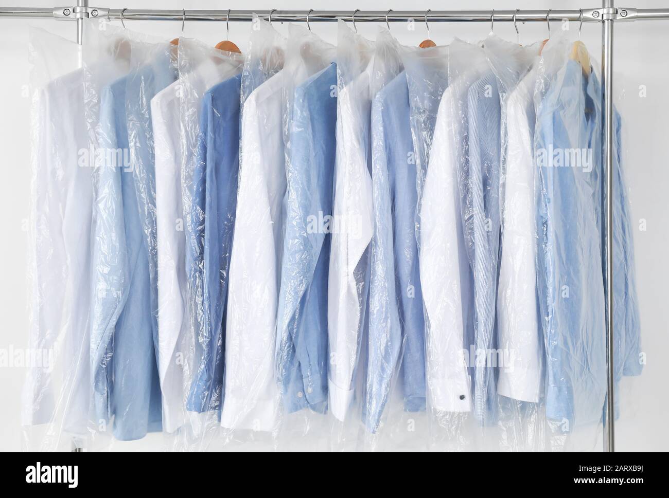 Rack with clothes in modern dry-cleaner's Stock Photo - Alamy