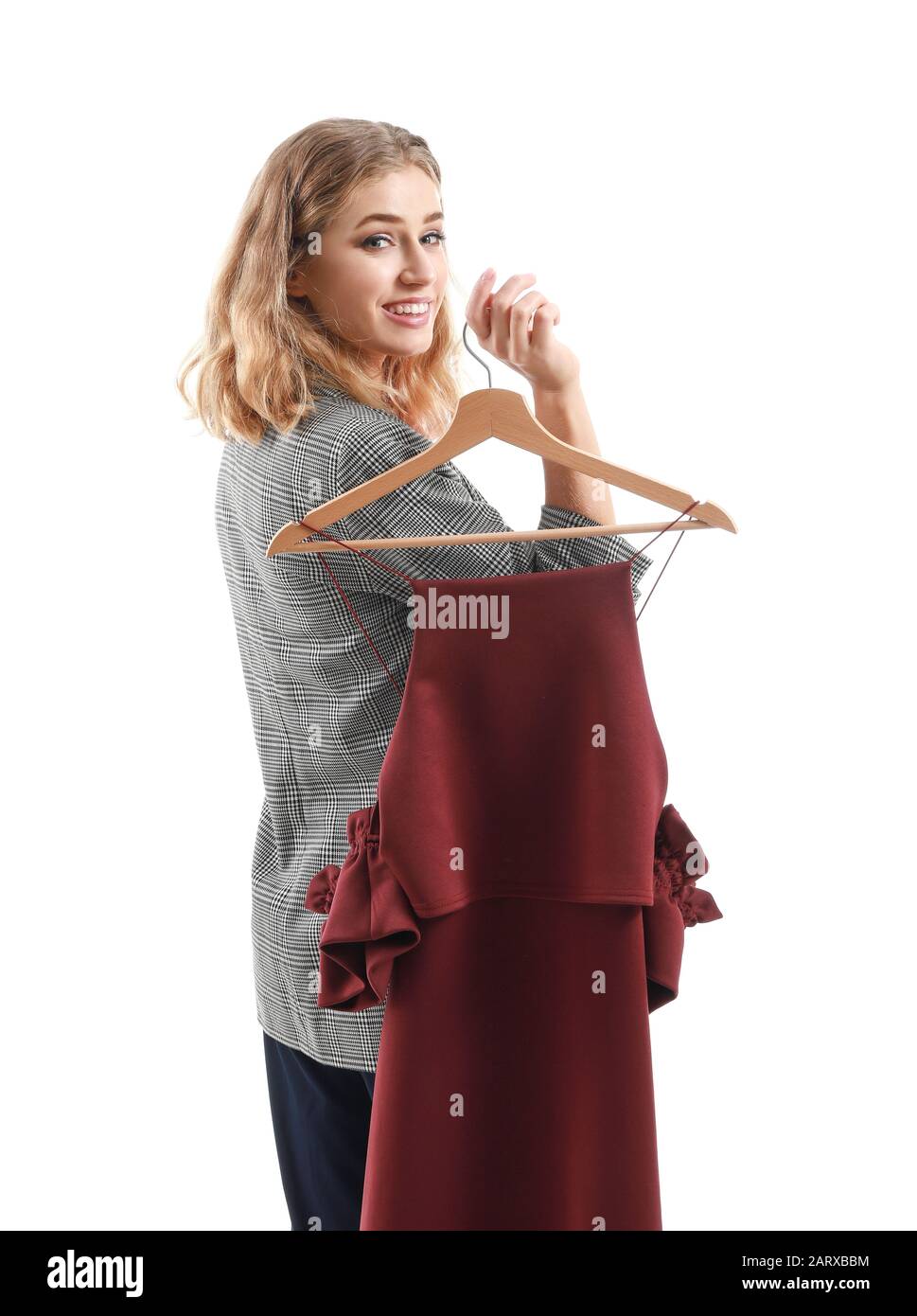 Female worker of modern dry-cleaner with clothes on white background ...