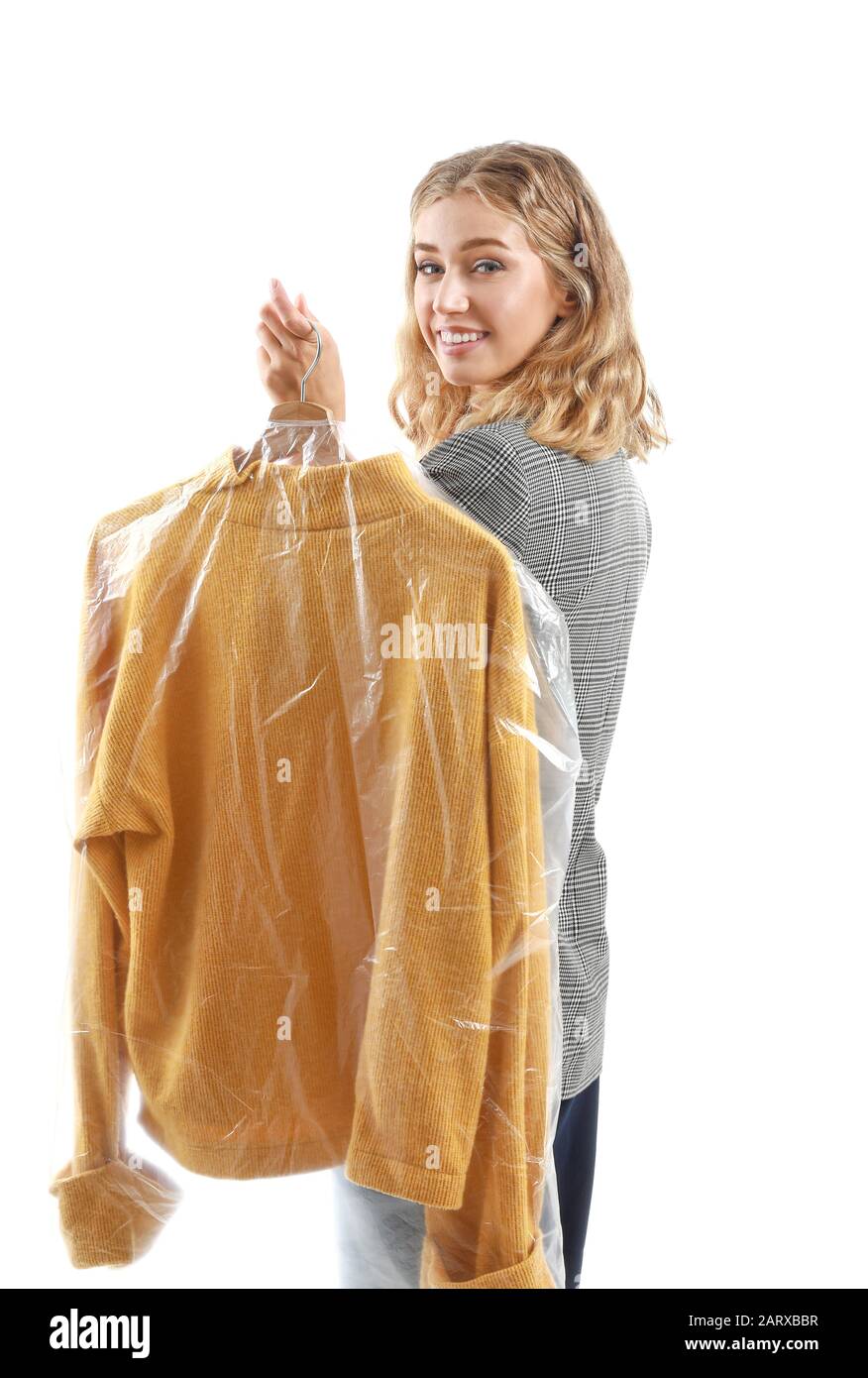 Female worker of modern dry-cleaner with clothes on white background ...