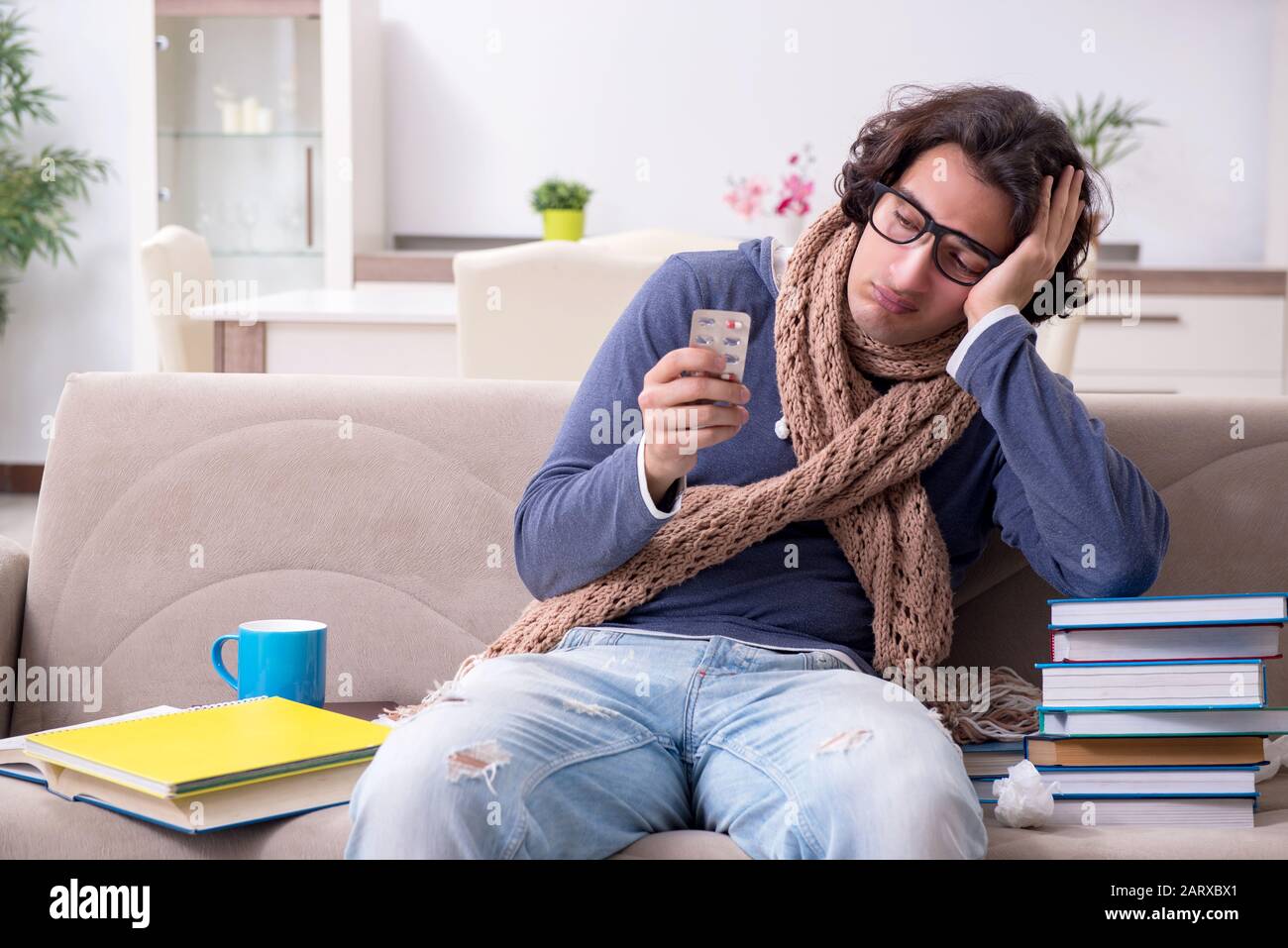 The sick male student suffering at home Stock Photo - Alamy