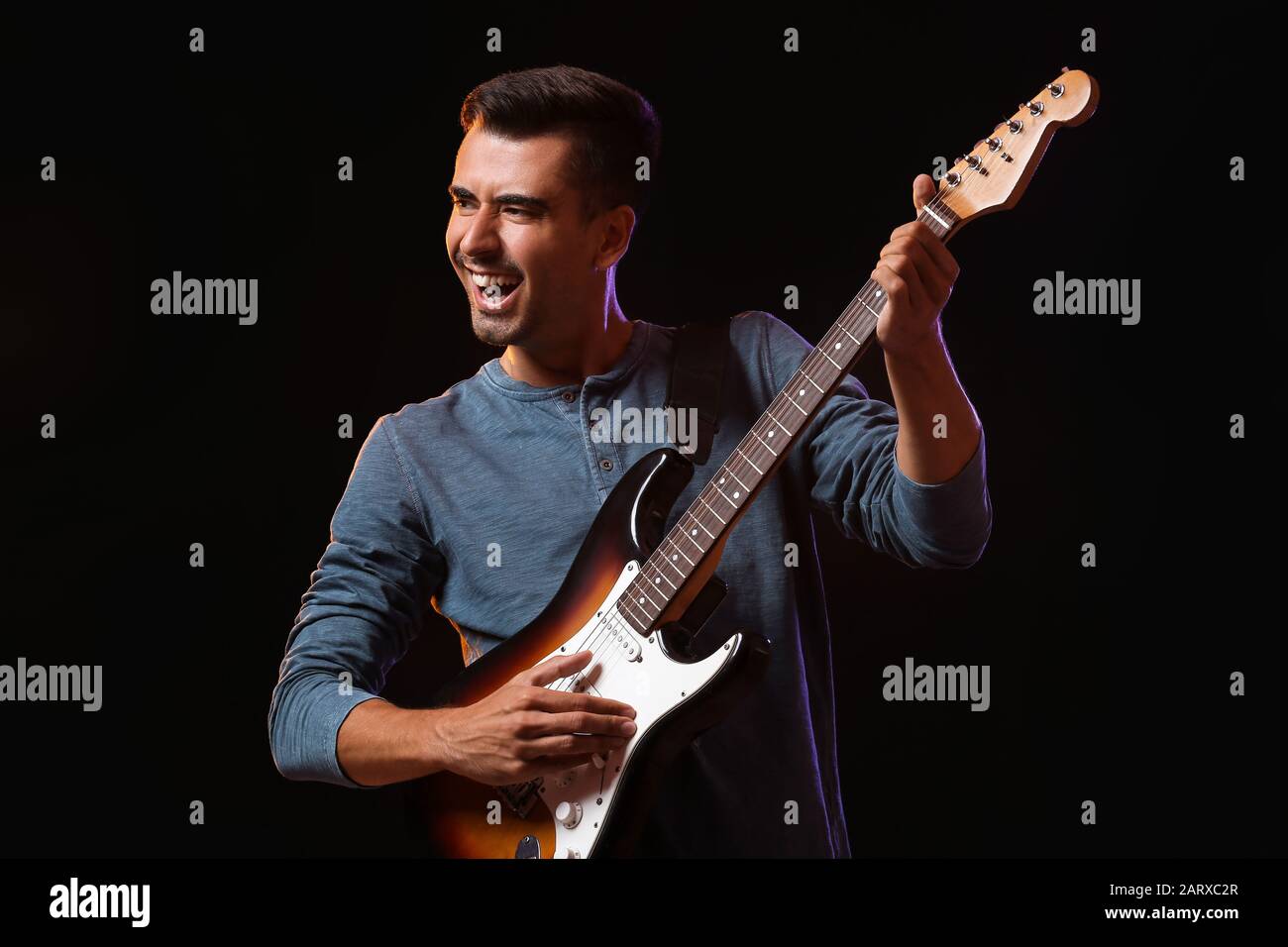 Handsome man playing guitar on stage Stock Photo - Alamy