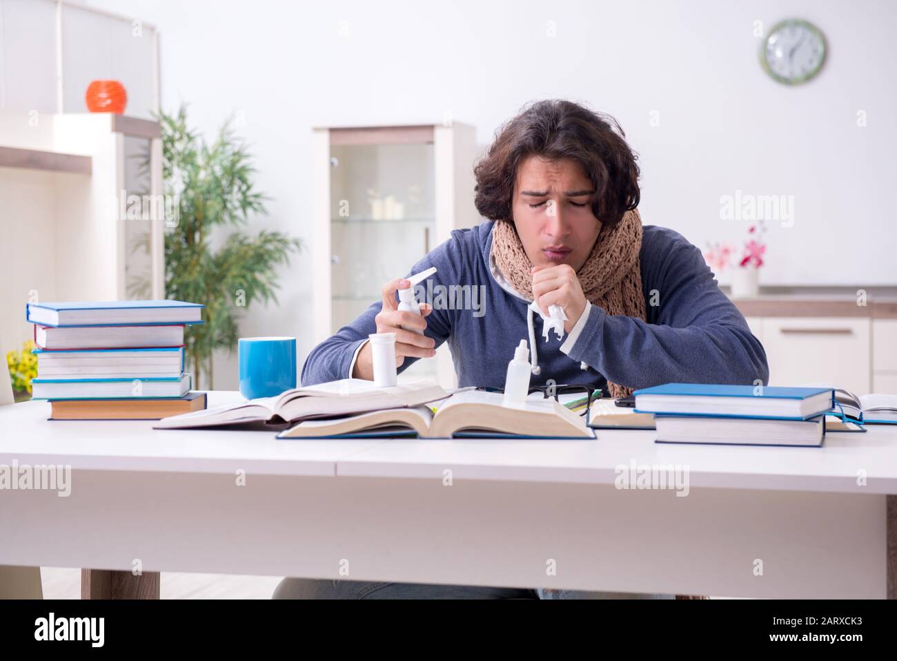 The sick male student suffering at home Stock Photo - Alamy