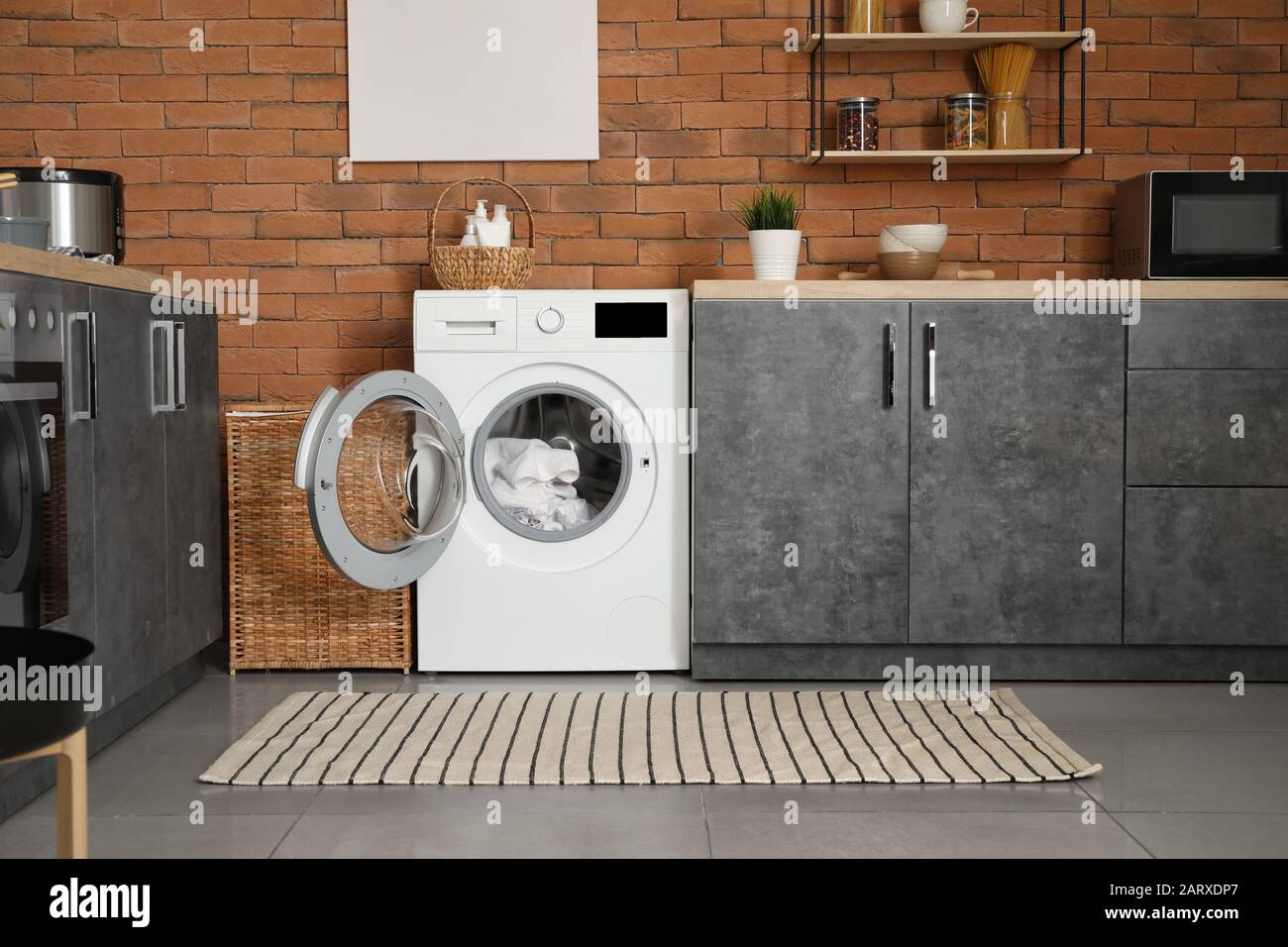 Interior of kitchen with modern washing machine Stock Photo - Alamy