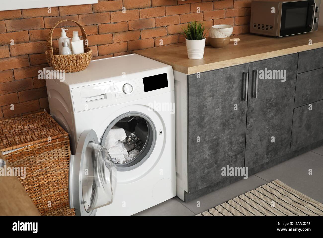 Interior of kitchen with modern washing machine Stock Photo - Alamy