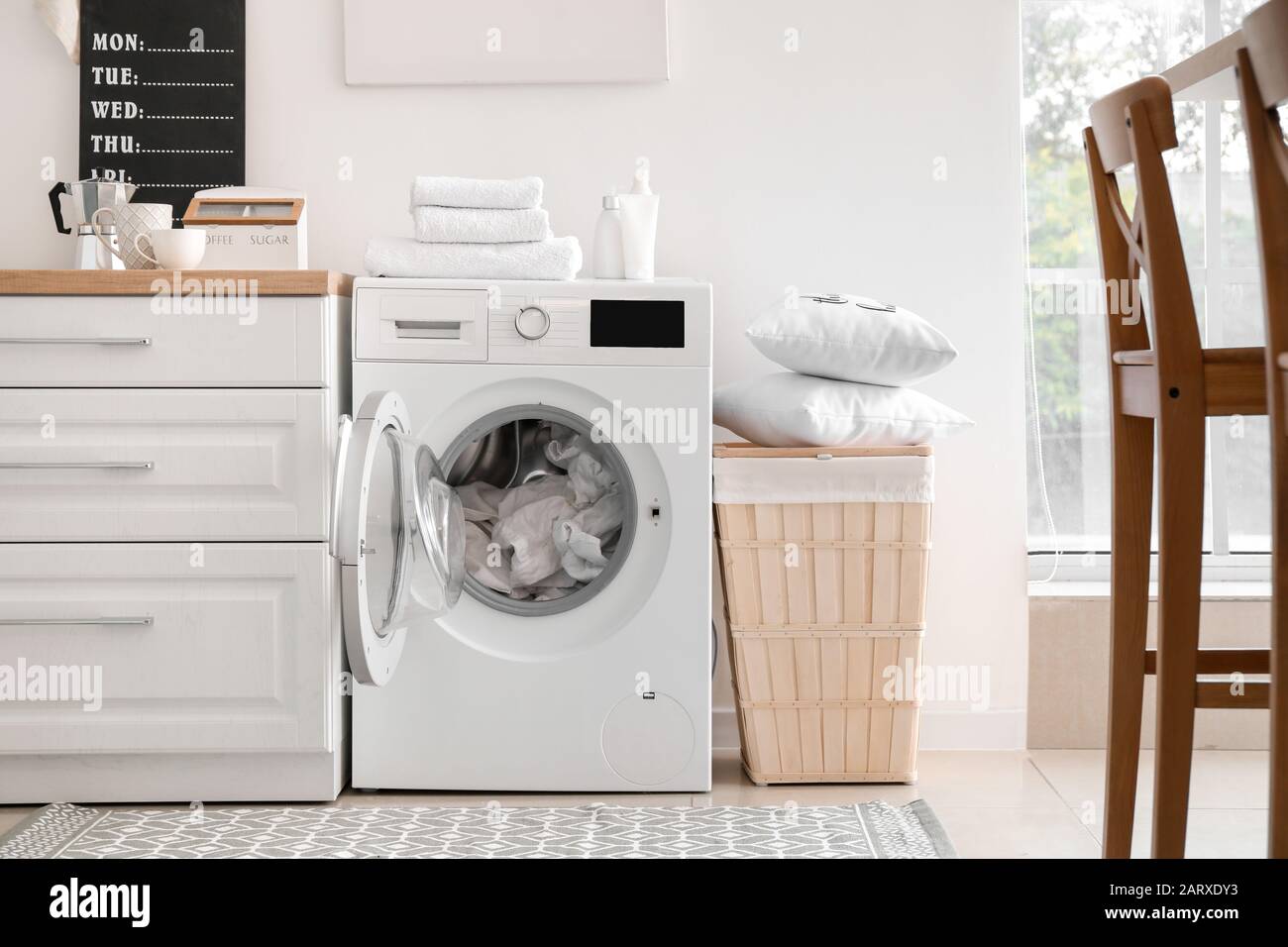 Interior of kitchen with modern washing machine Stock Photo - Alamy
