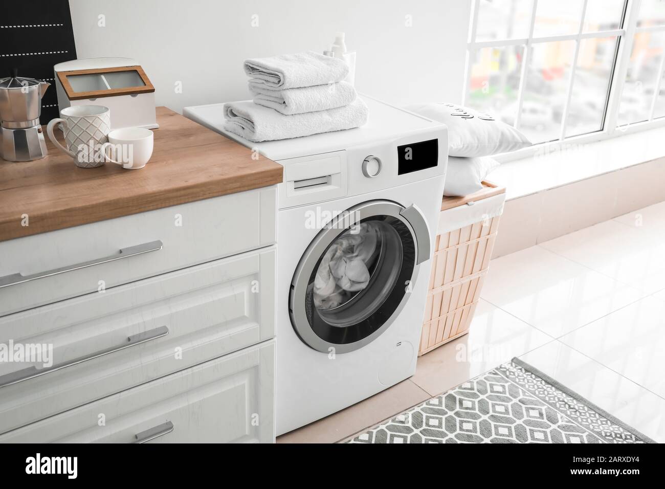 Interior of kitchen with modern washing machine Stock Photo - Alamy