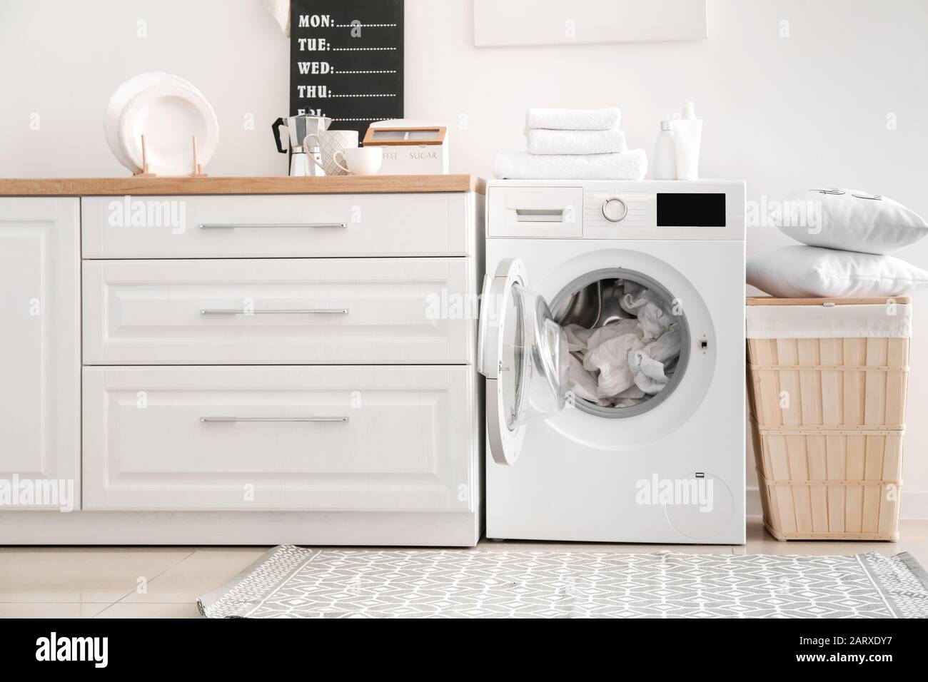 Interior of kitchen with modern washing machine Stock Photo - Alamy
