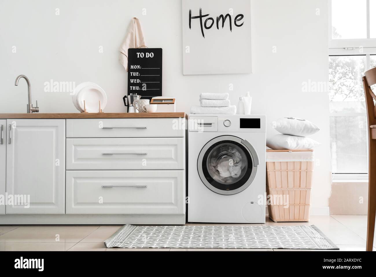 Interior of kitchen with modern washing machine Stock Photo - Alamy