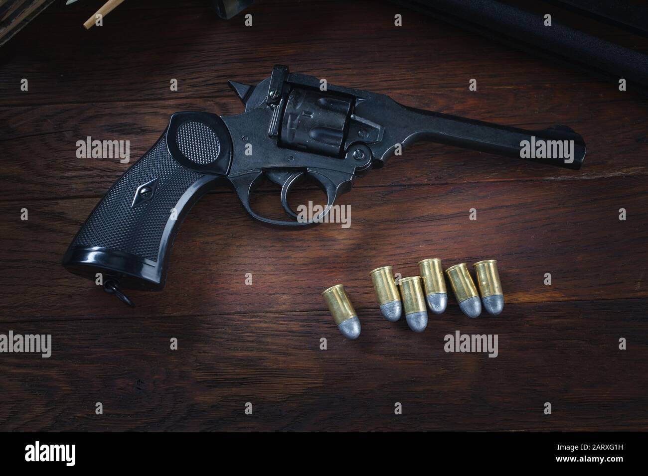 Retro vintage revolver gun with ammunitions on wooden table Stock Photo ...