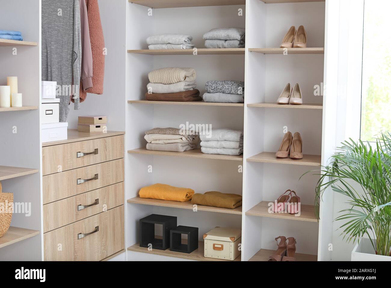 Wardrobe with stacks of clean clothes Stock Photo - Alamy