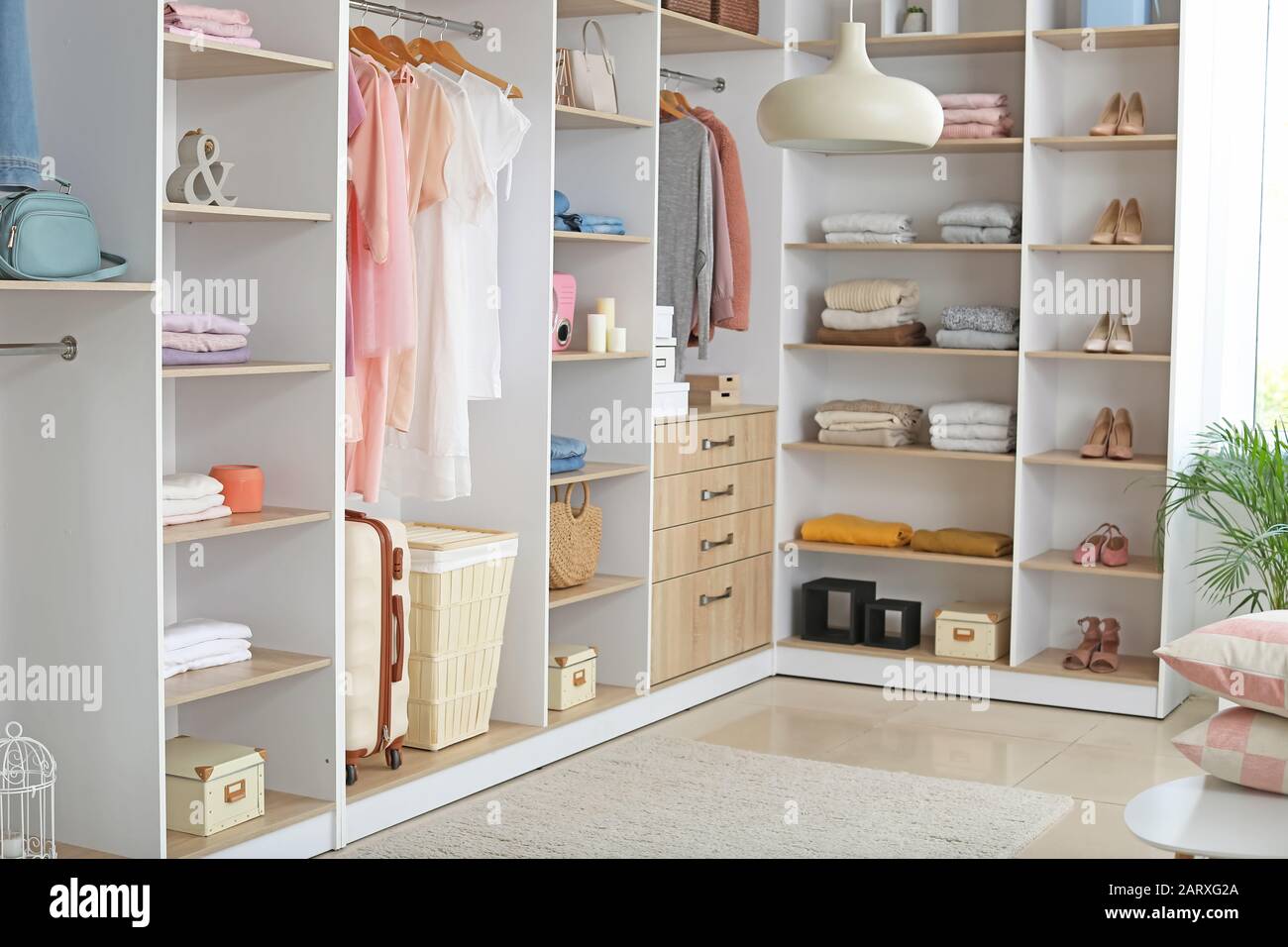 Wardrobe with stacks of clean clothes Stock Photo - Alamy