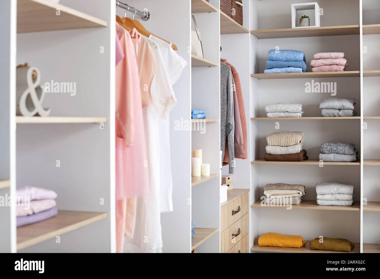 Wardrobe with stacks of clean clothes Stock Photo - Alamy