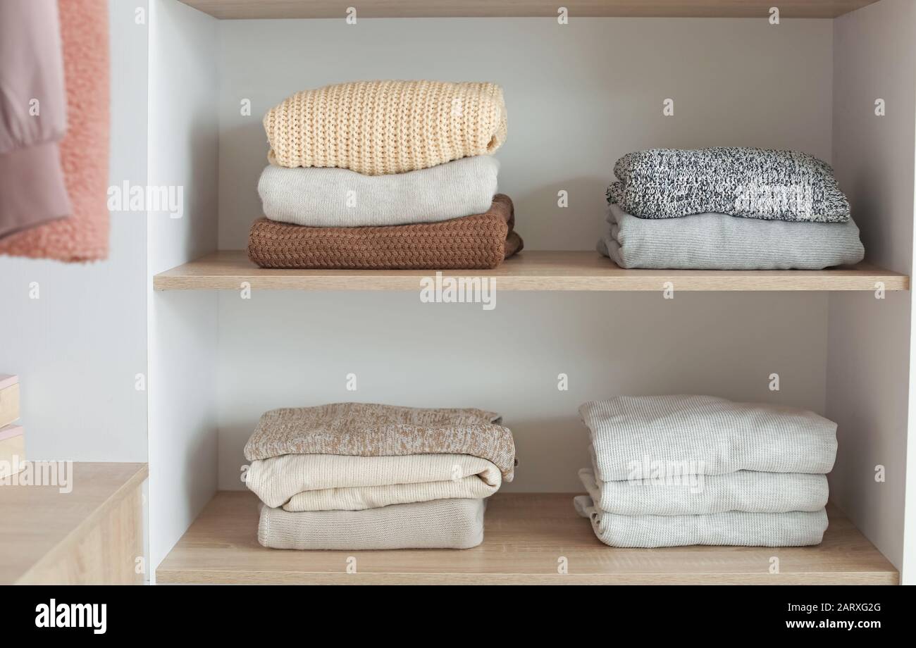 Wardrobe with stacks of clean clothes Stock Photo - Alamy