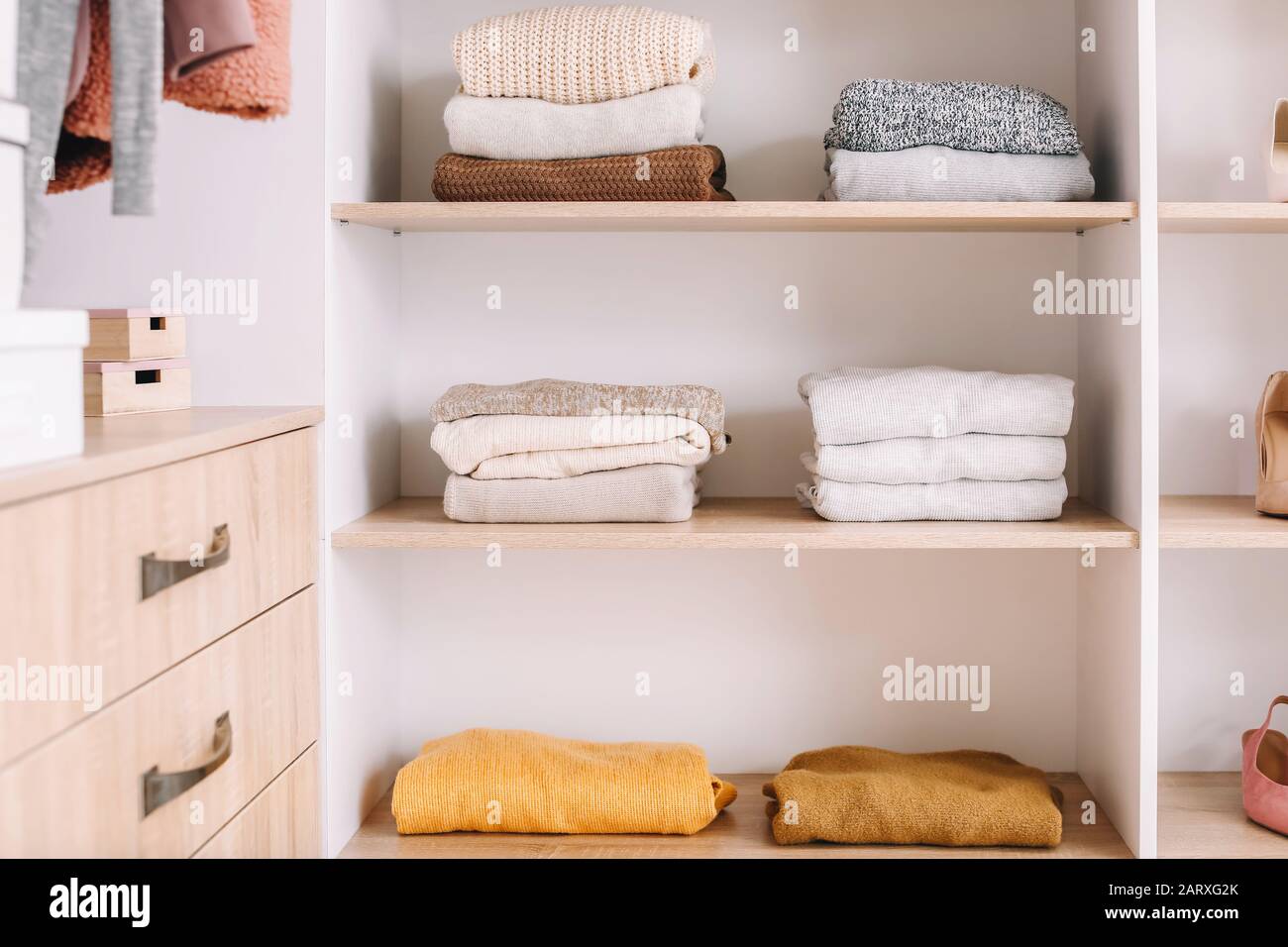 Wardrobe with stacks of clean clothes Stock Photo - Alamy