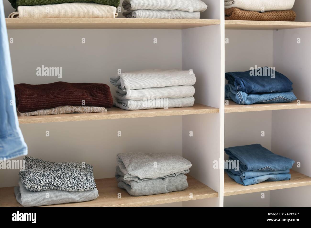 Wardrobe with stacks of clean clothes Stock Photo - Alamy