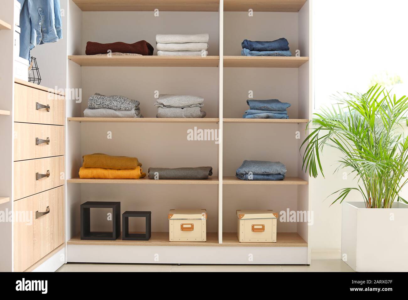 Wardrobe with stacks of clean clothes Stock Photo - Alamy