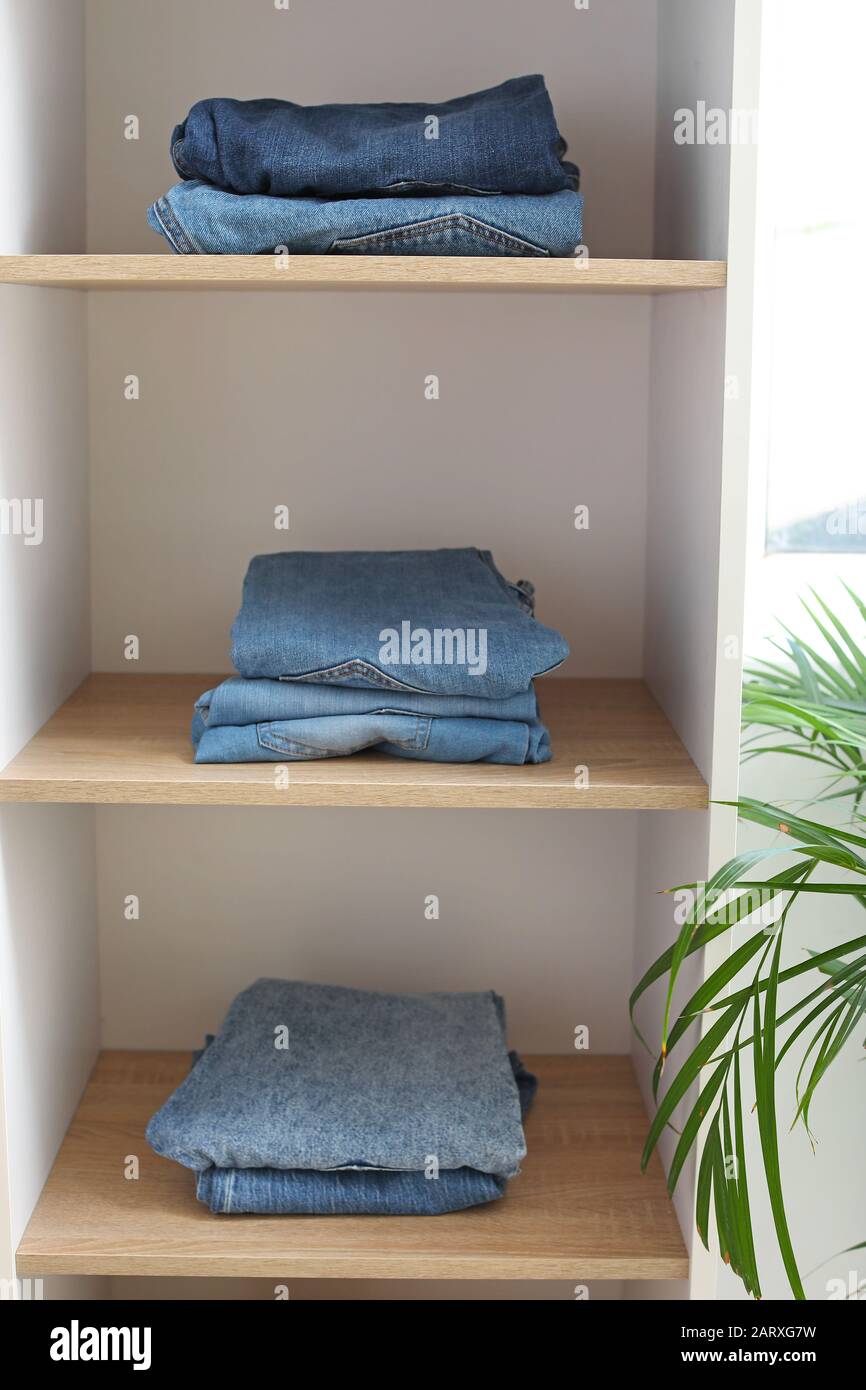 Wardrobe with stacks of clean clothes Stock Photo - Alamy